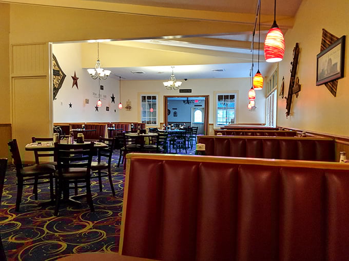 Burgundy booths and colorful pendant lights create that perfect diner atmosphere—where conversations flow as freely as the coffee refills.