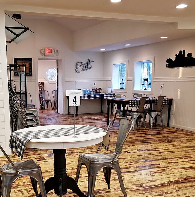The dining room's wooden floors and metal chairs tell stories of countless satisfied diners, while that "Eat" sign offers the simplest, most perfect instruction.