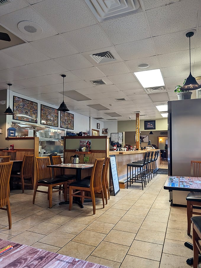 Classic diner ambiance at its finest—wooden tables, counter seating, and pendant lighting create that "come as you are" atmosphere where comfort trumps pretension.