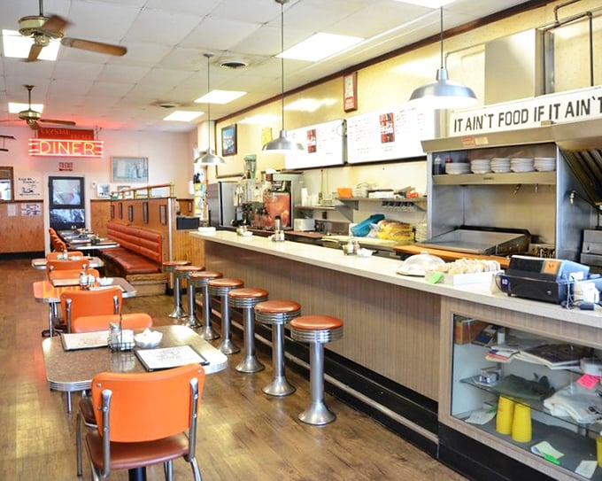 Classic Americana in every corner—chrome stools, orange chairs, and a counter where strangers become neighbors over coffee.