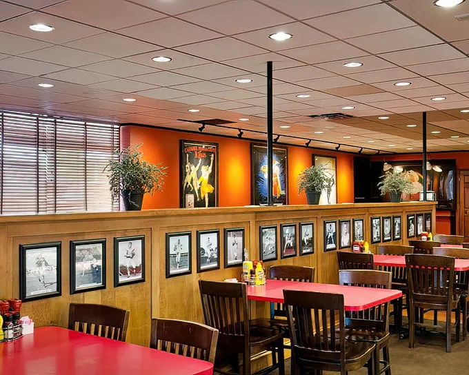 Warm wood paneling, vintage photographs, and those signature red tables create the perfect backdrop for the food memories you're about to make.