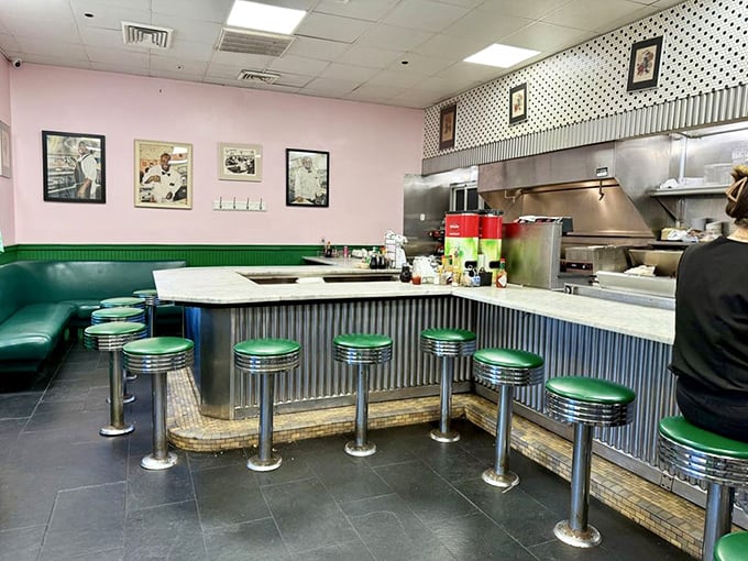 Counter culture at its finest—where green vinyl stools aren't just seats, they're front-row tickets to the most entertaining cooking show in New Orleans.