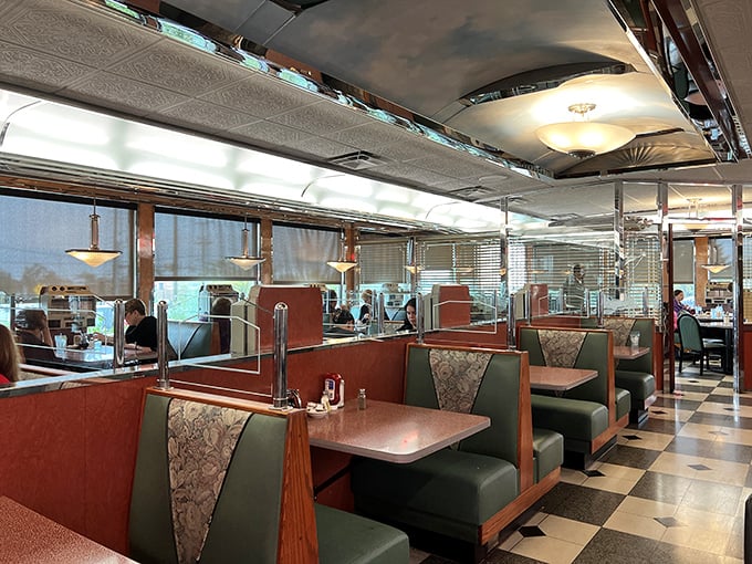 The interior is a symphony of vintage Americana—red vinyl booths, chrome accents, and that unmistakable checkerboard floor where countless coffee cups have been refilled.