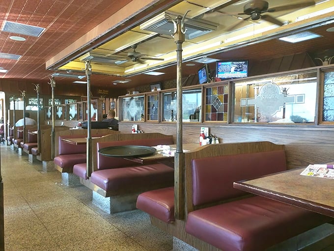 Classic burgundy booths and wood paneling create that timeless diner atmosphere where conversations flow as freely as the coffee. This isn't trendy—it's timeless.
