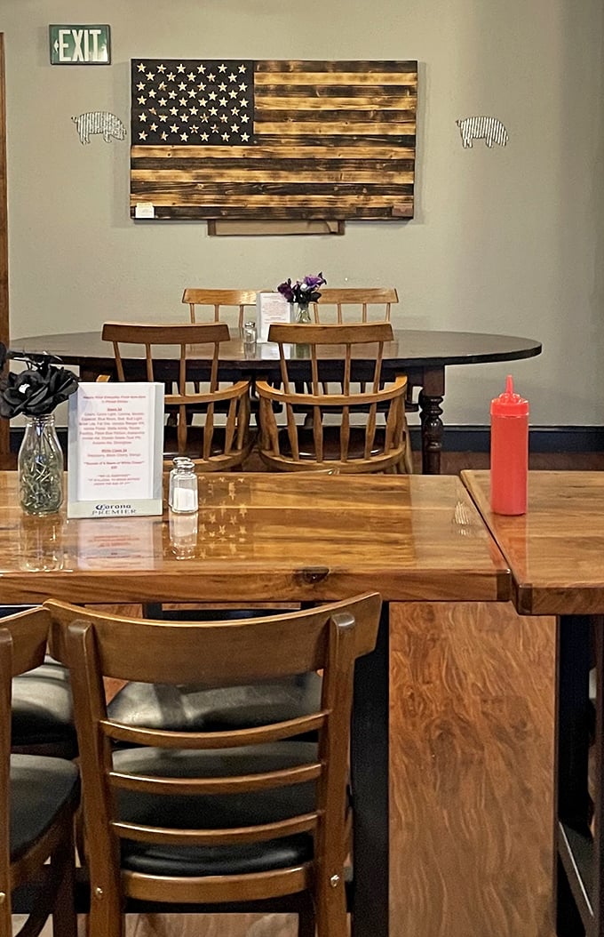 Simple wooden tables, American flag art, and squeeze bottles of sauce at the ready – BBQ paradise doesn't need fancy chandeliers to light up your taste buds.