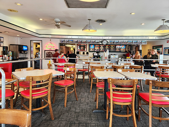 Step inside and you're transported to a simpler time—wooden tables, red chairs, and an atmosphere that feels both nostalgic and timeless.