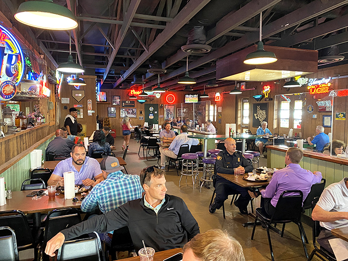 Where neon beer signs meet wood paneling and the serious business of barbecue happens. This isn't decor—it's a time capsule of Texas dining culture.