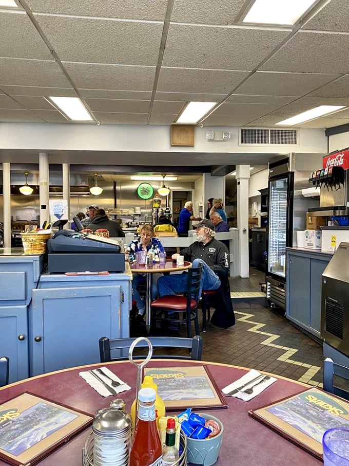 Blue booths and simple tables create the perfect backdrop for culinary magic. This isn't Instagram-bait décor—it's the real deal where conversations and memories are made.