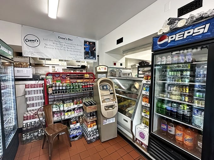 Efficiency in action! Every inch of space serves a purpose in this tiny deli where beverages, snacks, and an ATM compete for precious real estate.