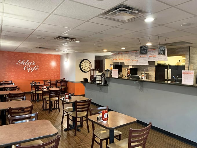 Inside, the warm orange accent wall and wooden furnishings create that perfect "come sit a spell" atmosphere where coffee refills and conversation flow freely.