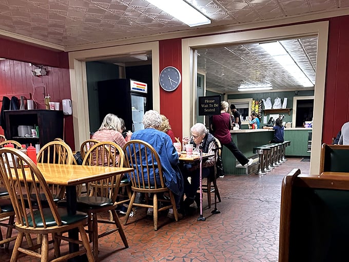 Red walls and wooden chairs create the perfect no-nonsense backdrop for serious eating. This isn't dining theater—it's barbecue church, and the congregation is hungry.