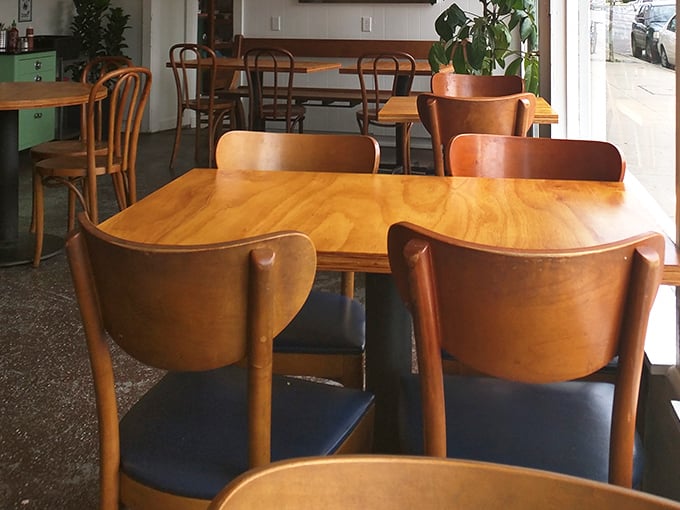 Warm wooden chairs invite lingering conversations over coffee and biscuits. This isn't just eating—it's therapy with carbs.