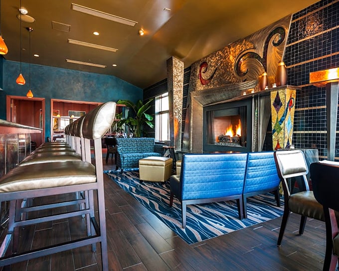 That fireplace isn't just for show – it's the beating heart of a dining room where comfort meets sophistication.