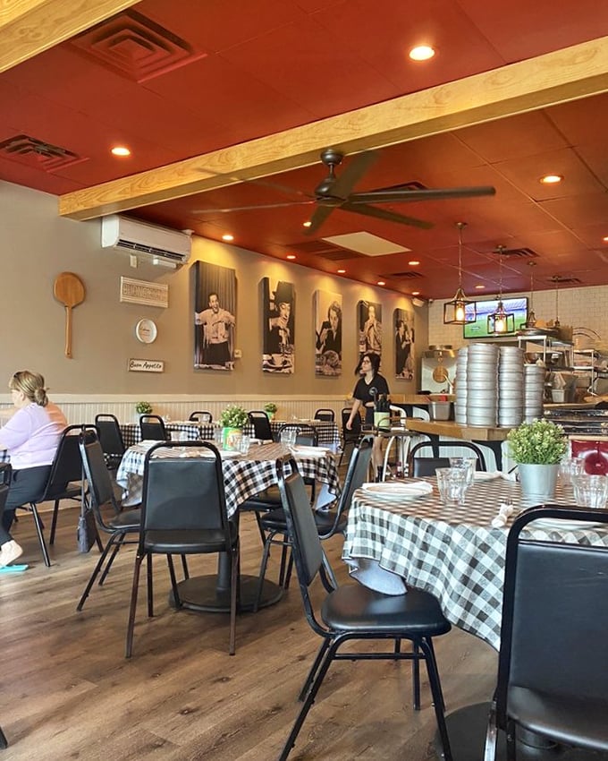 Red ceiling, checkered tablecloths, and Italian icons watching over your meal. This isn't decoration—it's a promise of authenticity.
