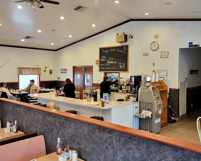 The classic diner counter setup at Mary's—where regulars perch like birds on a wire, watching breakfast magic unfold.