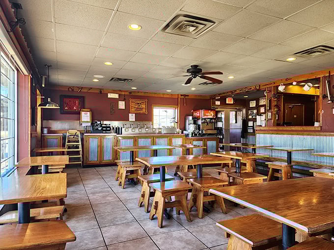 Wooden tables, corrugated metal accents, and ceiling fans create that perfect "come as you are" atmosphere where napkins aren't optional.