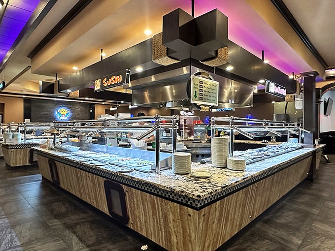Buffet royalty deserves a proper throne room. The sleek serving stations gleam under purple-blue lighting, promising an endless parade of delicacies.
