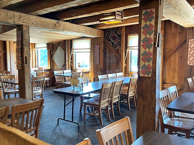 Exposed wooden beams and handcrafted quilts create a dining atmosphere that feels like stepping into a warm hug from rural America's past.