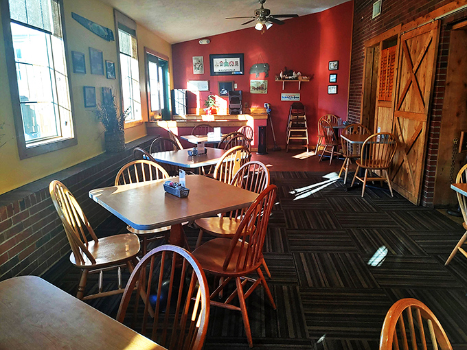 Wooden chairs, warm colors, and sunlight streaming through windows create the perfect backdrop for comfort food conversations.