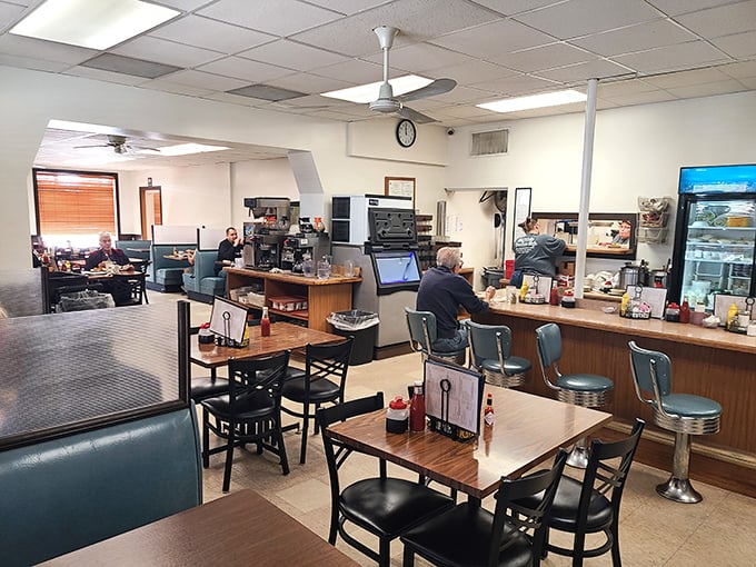 Classic diner perfection: swivel stools at the counter, blue vinyl booths, and that unmistakable buzz of coffee cups and conversation that feels like coming home.