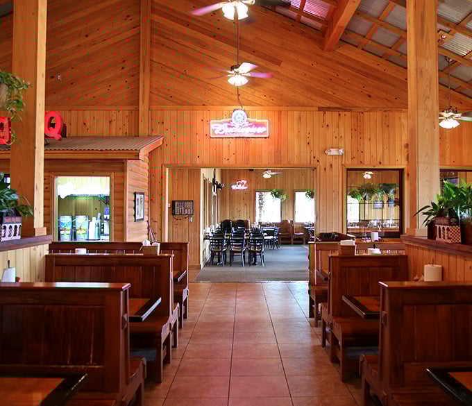 Cathedral-like wooden beams soar overhead while booth seating keeps conversations intimate. This isn't architecture – it's BBQ atmosphere engineering.