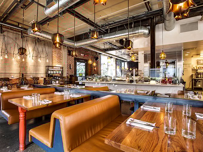Industrial chic meets Italian warmth where exposed ducts and copper lighting hover above leather banquettes, creating LA's perfect marriage of grit and glamour.