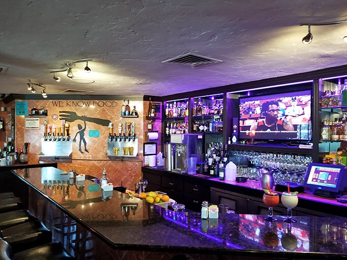 The purple-lit bar creates an ambiance that's sophisticated without being stuffy—perfect for serious eating and casual conversation.