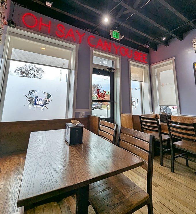 "OH SAY CAN YOU SEE" the neon sign asks, and indeed you can—simple wooden tables waiting for the messy, magnificent ritual of Maryland crab feasting.