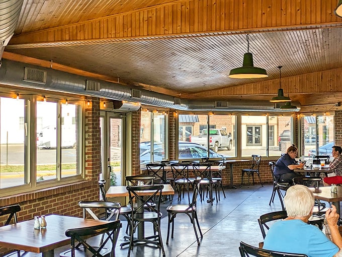 Wooden ceilings, exposed brick, and industrial lighting create the perfect backdrop for the smoky drama about to unfold on your plate.