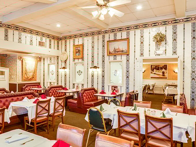 Red leather booths and striped wallpaper create that classic Italian-American restaurant vibe—where memories are made between bites of pasta.