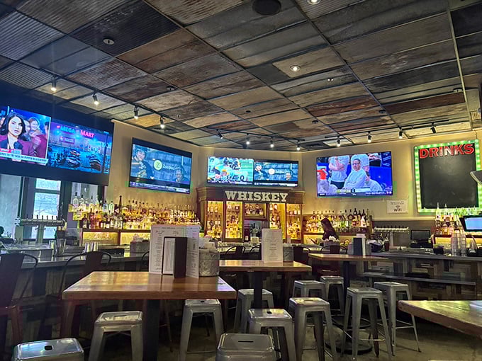 Not just a bar, but a shrine to whiskey where TVs broadcast sports and the corrugated ceiling hints at serious barbecue business below.