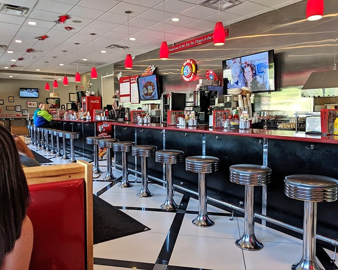 Classic Americana at its finest – chrome stools, checkered floors, and conversations that flow as freely as the coffee.