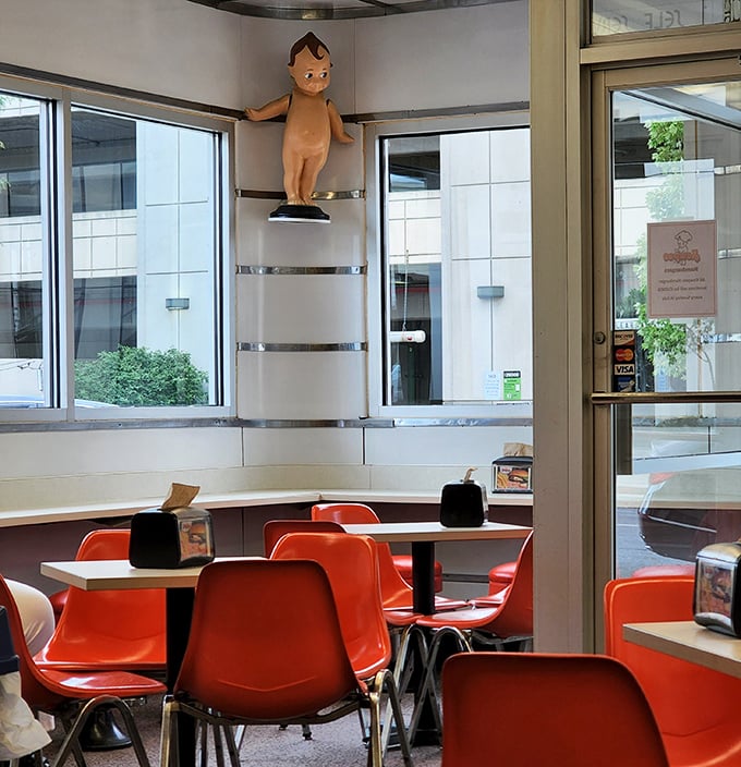 Inside, those vibrant orange chairs and vintage decor aren't trying to be retro—they're the real deal, preserved from an era when dining out was an event.