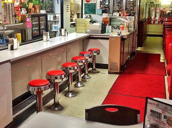The red counter stools at K's aren't just seats – they're front-row tickets to the greatest show in Troy: breakfast and burgers made the old-school way.