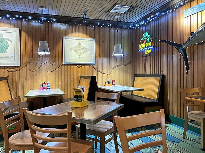 Wood-paneled walls adorned with marine artwork and string lights create that perfect "come as you are" atmosphere where memorable meals happen.