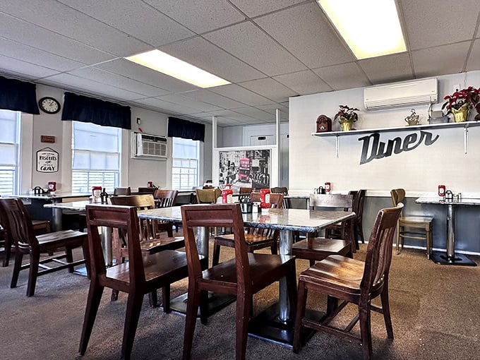 Inside, wooden chairs and pristine tables create that perfect small-town diner atmosphere where conversations flow as freely as the coffee.