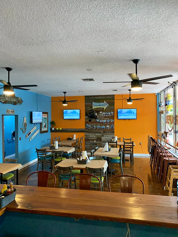 Bright orange walls and weathered wood accents create that perfect "Old Florida meets modern comfort" vibe that makes you instantly feel like a regular.