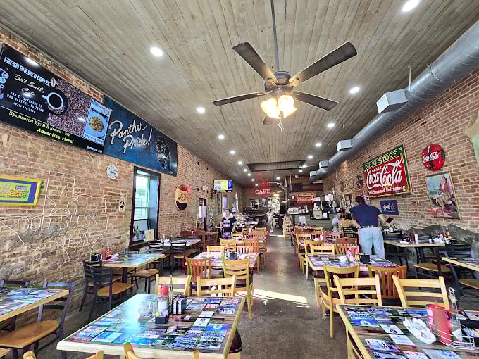 Exposed brick, Coca-Cola nostalgia, and ceiling fans—this isn't a museum, it's where great food meets authentic small-town charm.