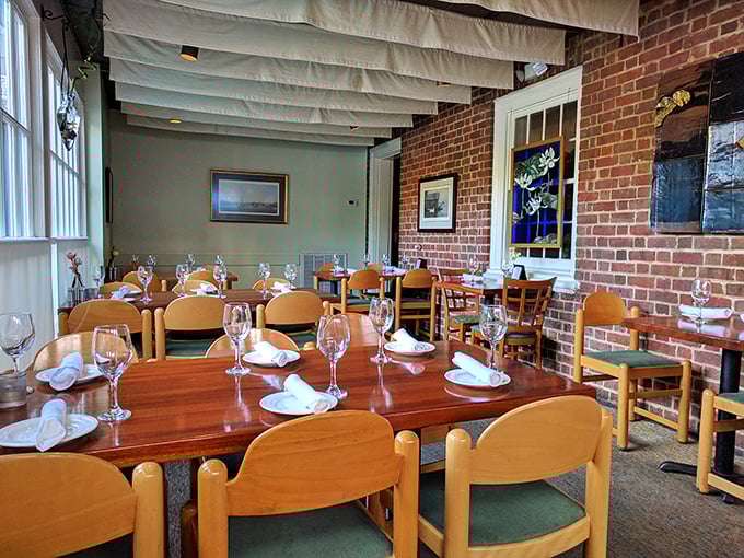 Exposed brick meets nautical charm in this dining room where every table setting whispers, "Something wonderful from the sea is about to happen here."