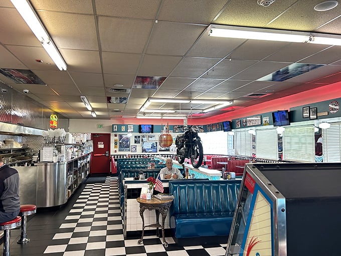 Black and white tiles that would make a chess champion feel at home lead to turquoise booths where comfort food dreams come true. That motorcycle isn't going anywhere—except maybe into your Instagram feed.