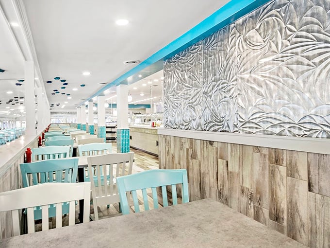 Coastal elegance meets comfort in this airy dining space. The sea-inspired wall art and turquoise chairs create an atmosphere that says, "Stay awhile, the ocean's bounty awaits."