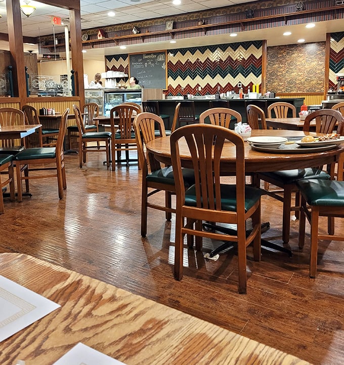 Wooden chairs, warm lighting, and that distinctive chevron wall pattern – this isn't interior design, it's a time machine to simpler, delicious days.