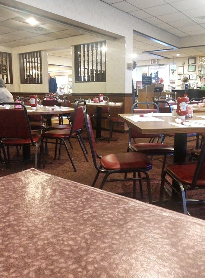 Classic diner charm at its finest – red vinyl chairs and wood paneling create the perfect backdrop for morning coffee rituals.