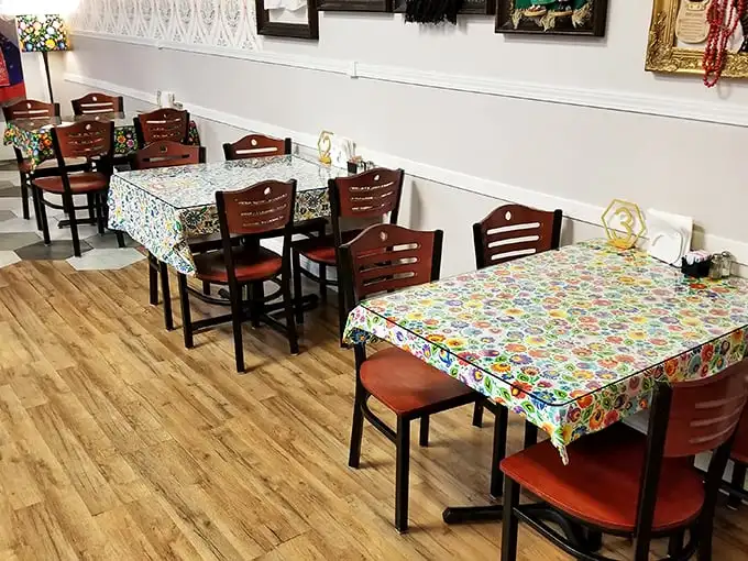 The dining room's colorful tablecloths and wooden chairs create that "grandma's kitchen" vibe where you know every bite will taste like love.