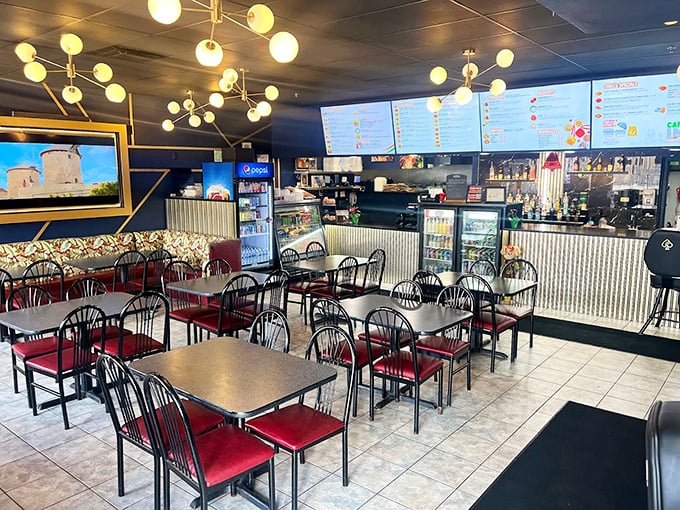 Inside, modern lighting fixtures hover above simple tables with red chairs—proof that great food doesn't need fancy surroundings to shine.