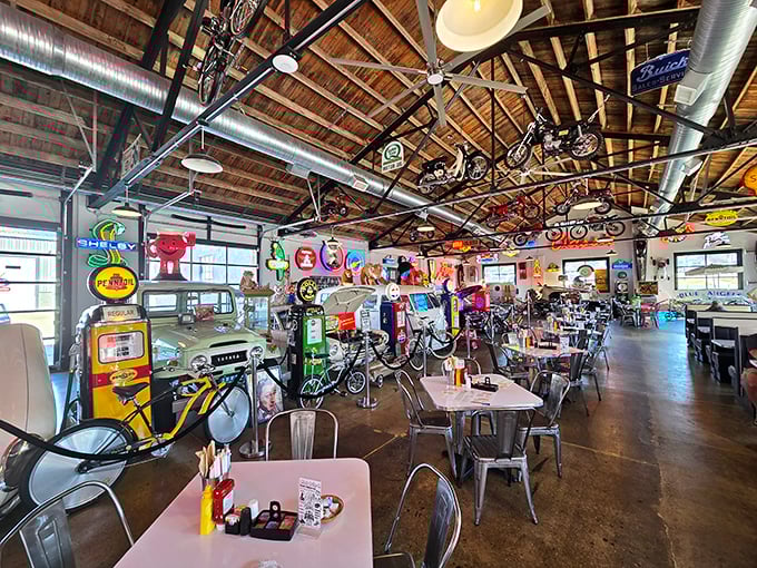 Bicycles suspended from wooden rafters, vintage signs on every wall—this isn't decoration, it's a museum where you can eat.