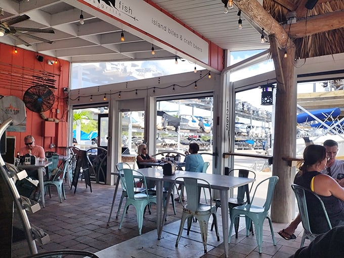 Metal chairs and marina views create the kind of casual elegance that fancy restaurants spend fortunes trying to fake.