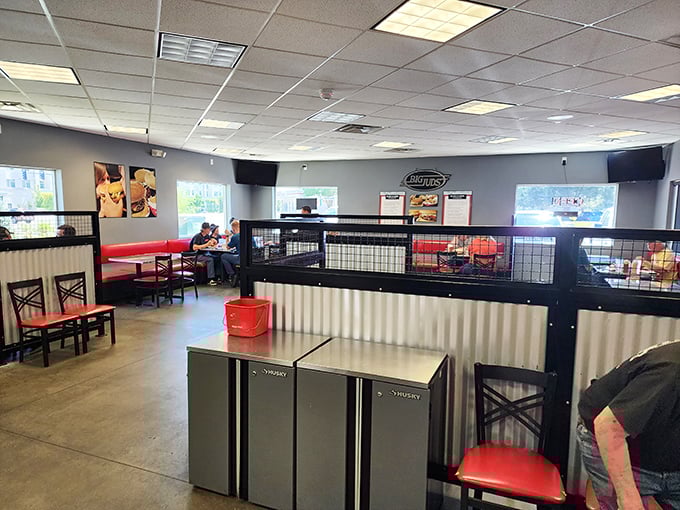 Inside, the no-frills interior with red accents and metal dividers says, "We're not here for the ambiance—we're here for the burgers."