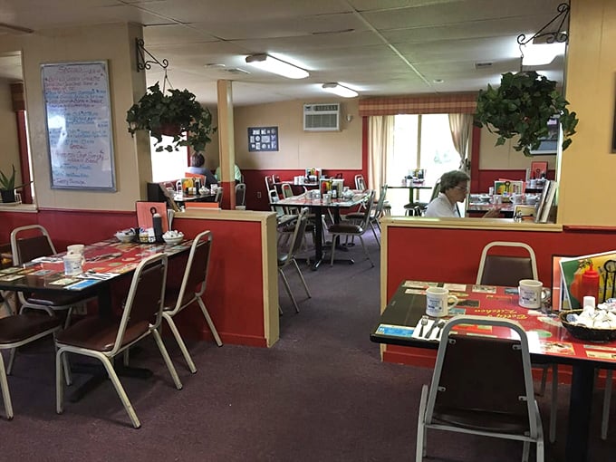 Red wainscoting meets yellow walls in this diner where comfort isn't just on the menu – it's built into every surface, hanging plant, and welcoming booth.