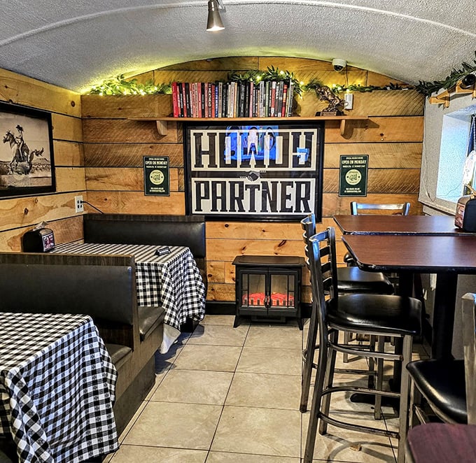 "HOWDY PARTNER" isn't just wall decor—it's the unofficial motto of this cozy wood-paneled sanctuary where checkered tablecloths signal delicious messiness ahead.